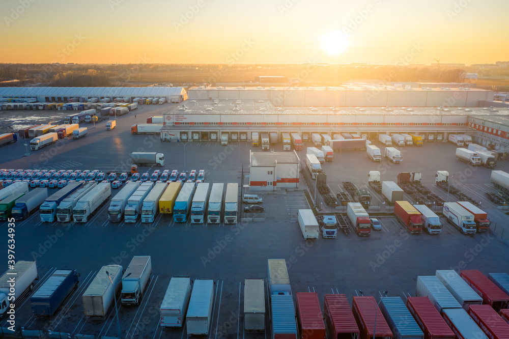 Logistics park with warehouse, loading hub and many semi trucks with ...