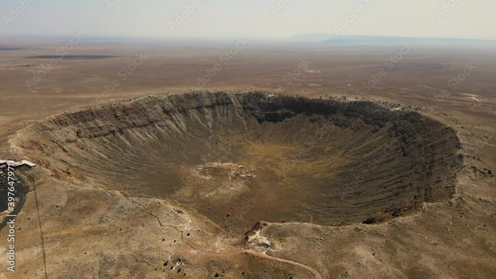 Cinematic aerial flyover of prehistoric impact crater in the Southwest ...