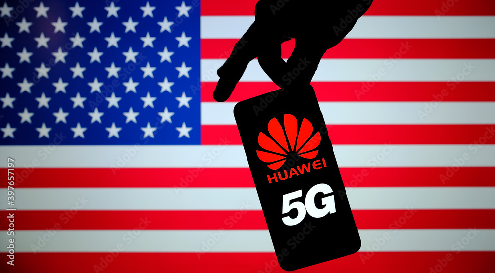 Huawei logo on smartphone silhouette and hand pointing at it. The US ...