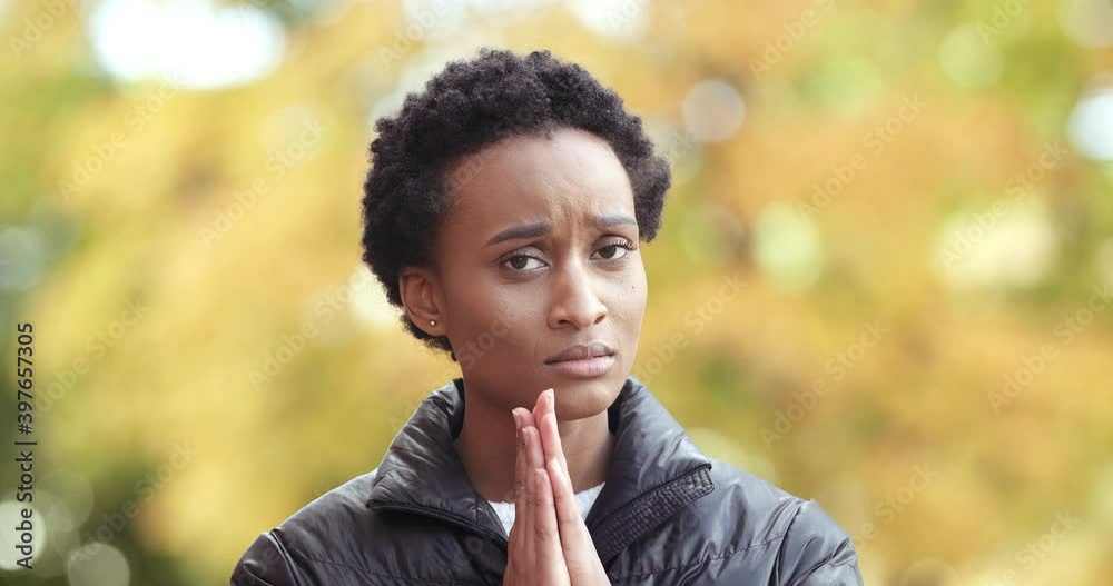 Sad dark skinned black woman looks with pleading expression asks to ...