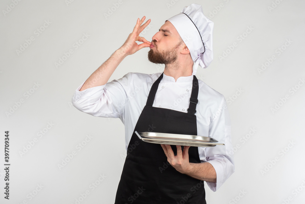 Chef man. Portrait of chef cook showing empty tray. Cook shows ...