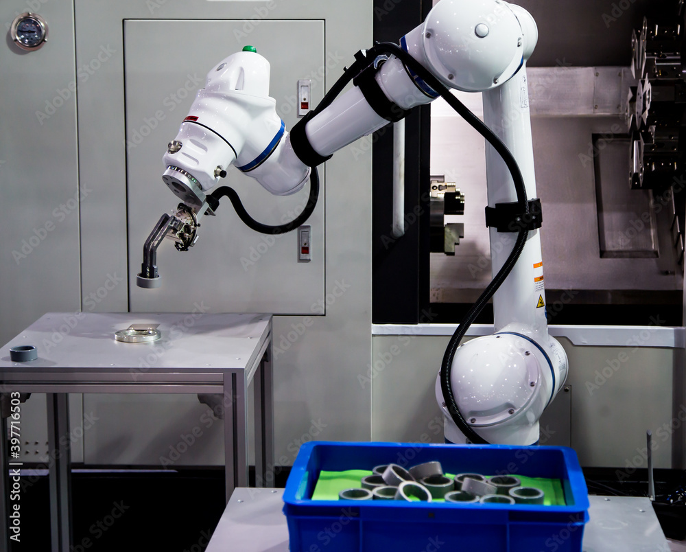 Automated process industrial robot loading metal part to CNC machine ...