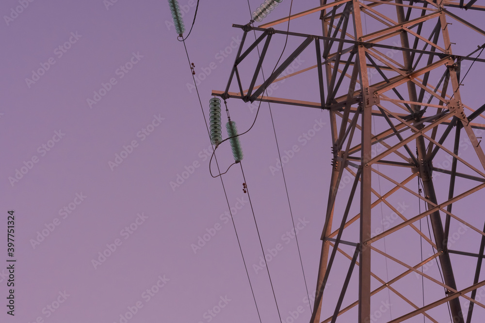 Power line at sunset. The main purpose of power lines is to transmit ...