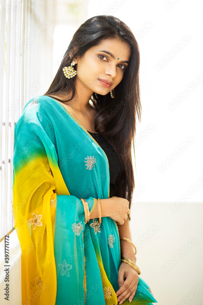 Pretty Indian young woman in traditional dress on white. Stock Photo ...