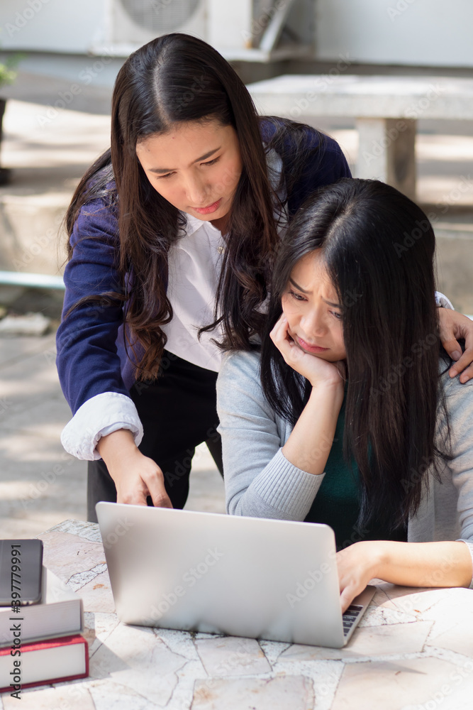 Serious asian woman college student studying in university campus with ...