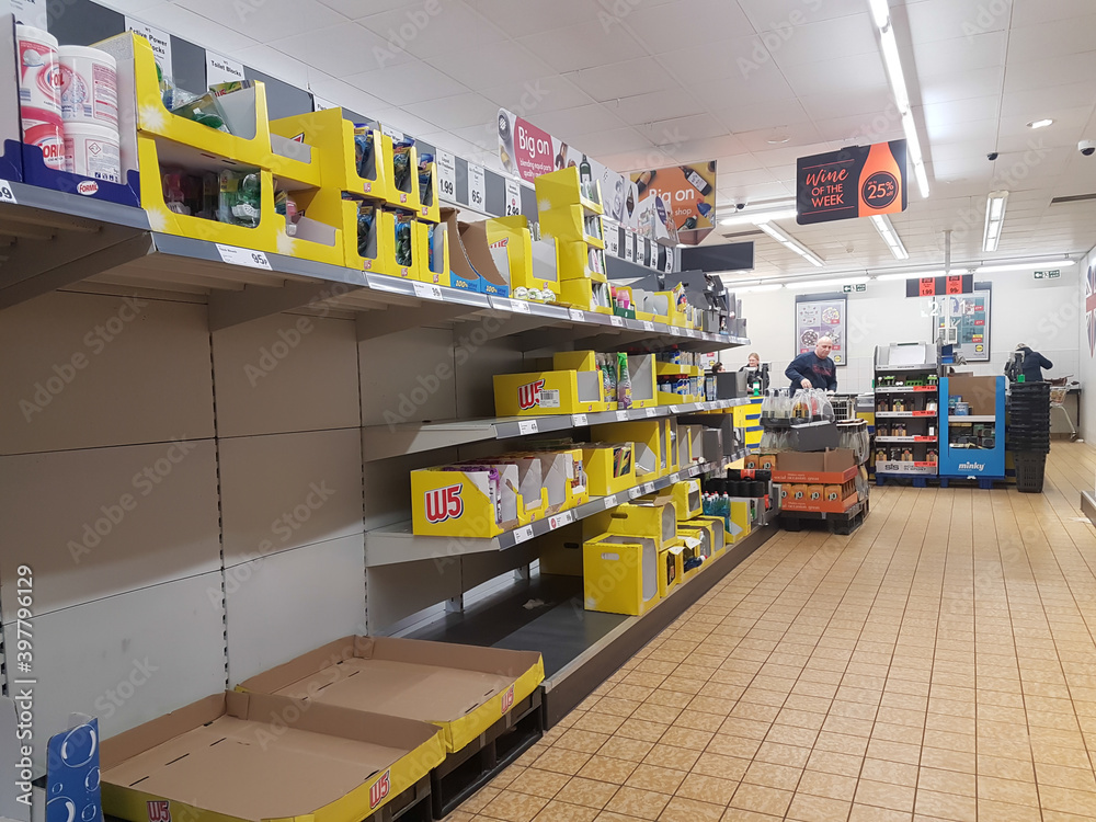 Empty retail shop shelves in a supermarket. Low supplies due to ...