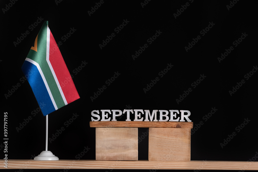 Wooden calendar of September with RSA flag on black background. Dates ...