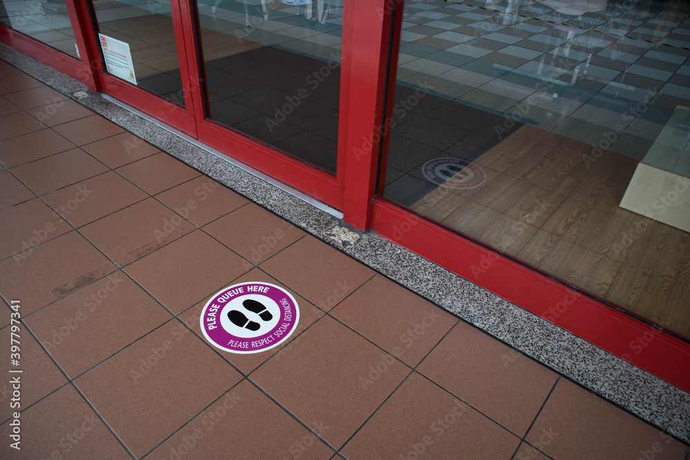 Social Distance information reminder sticker saying Please Queue Here ...