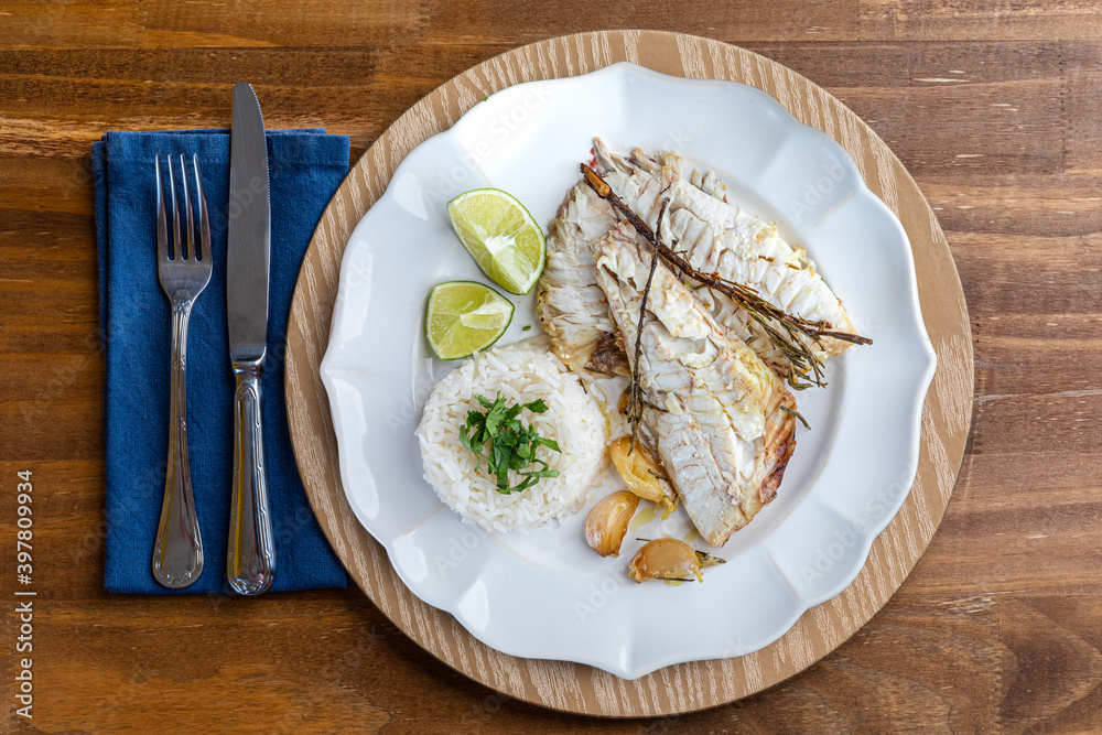 Roasted red fish (Olho de Cão in Brazil) seasoned with herbs, garlic ...