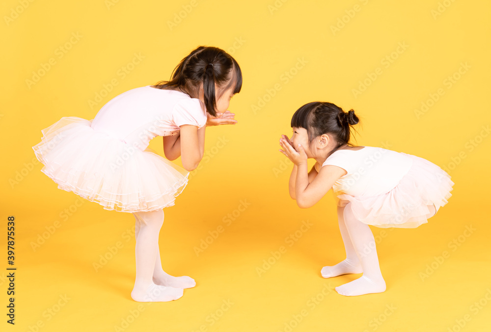 Foto de Cute ballerina two little Asian girls talking relaxed after ...