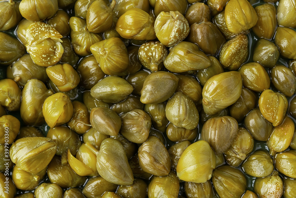 Pickled capers as a background. Marinated buds of caper bush ...