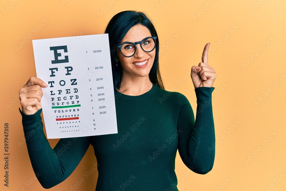 Young caucasian woman holding optometry glasses and eyesight test ...