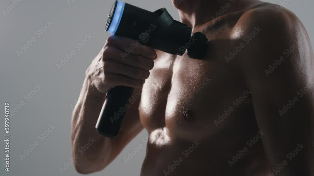 sports man uses muscle massager Stock Video | Adobe Stock