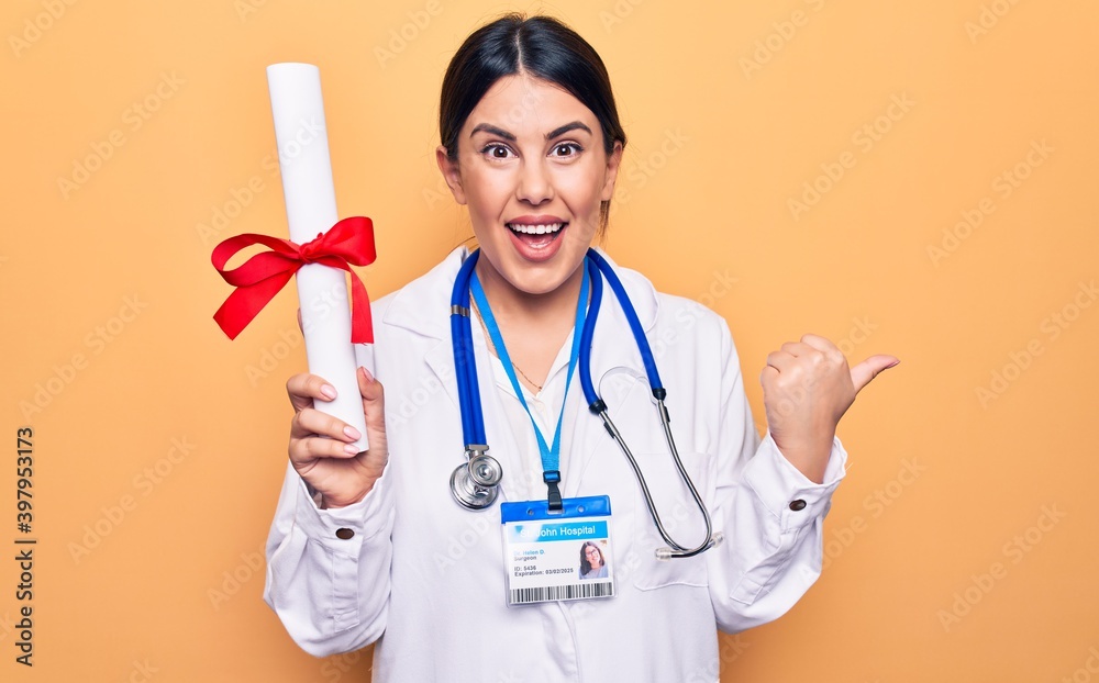 Young beautiful doctor woman wearing stethoscope holding diploma degree ...