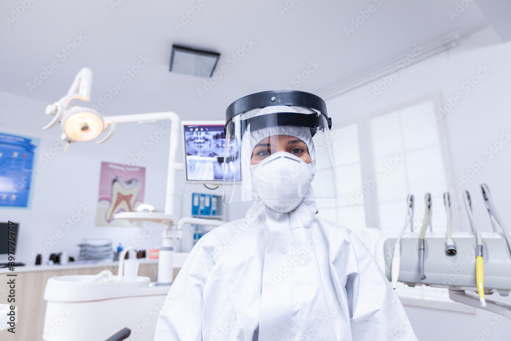 Patient first person view of dentist wearing safety gear against ...