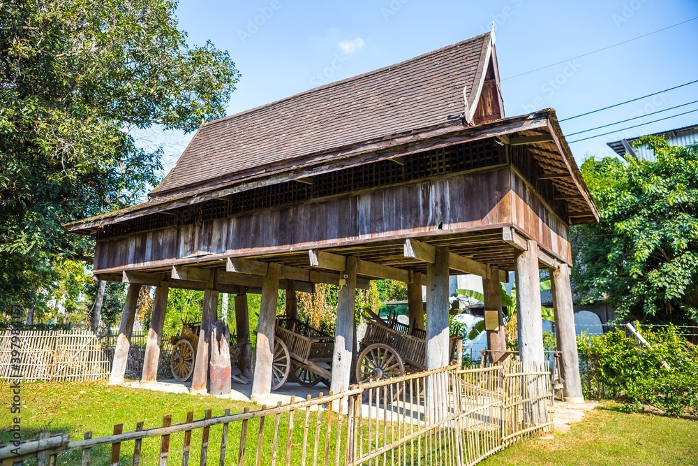 Traditional Thai style rice barn with wooden cart under the barn ...
