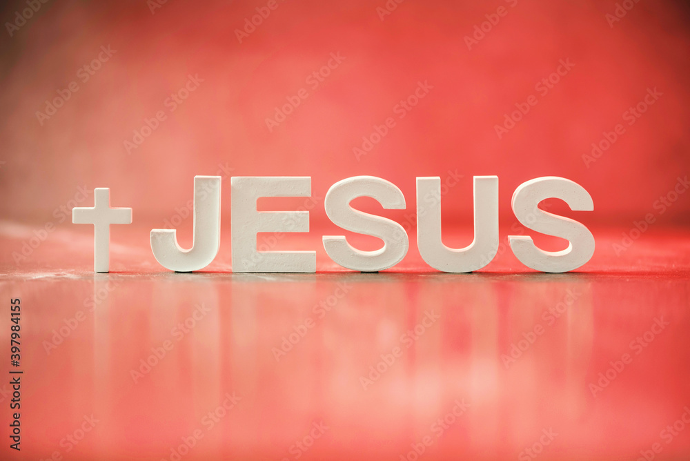 Name JESUS made with cement letters on red light marble background ...