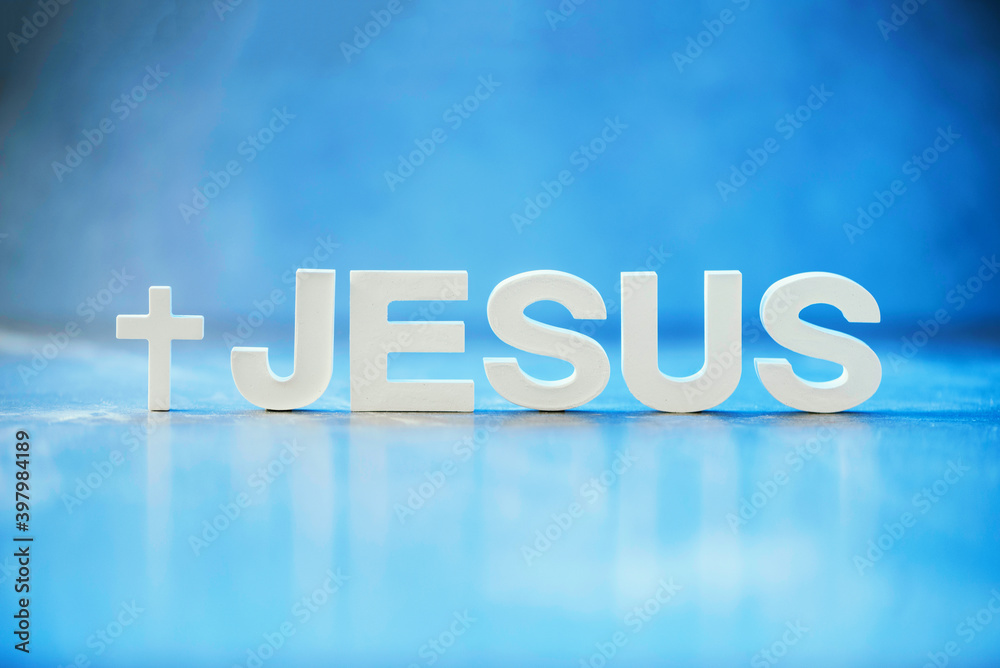 Name JESUS made with cement letters on blue light marble background ...