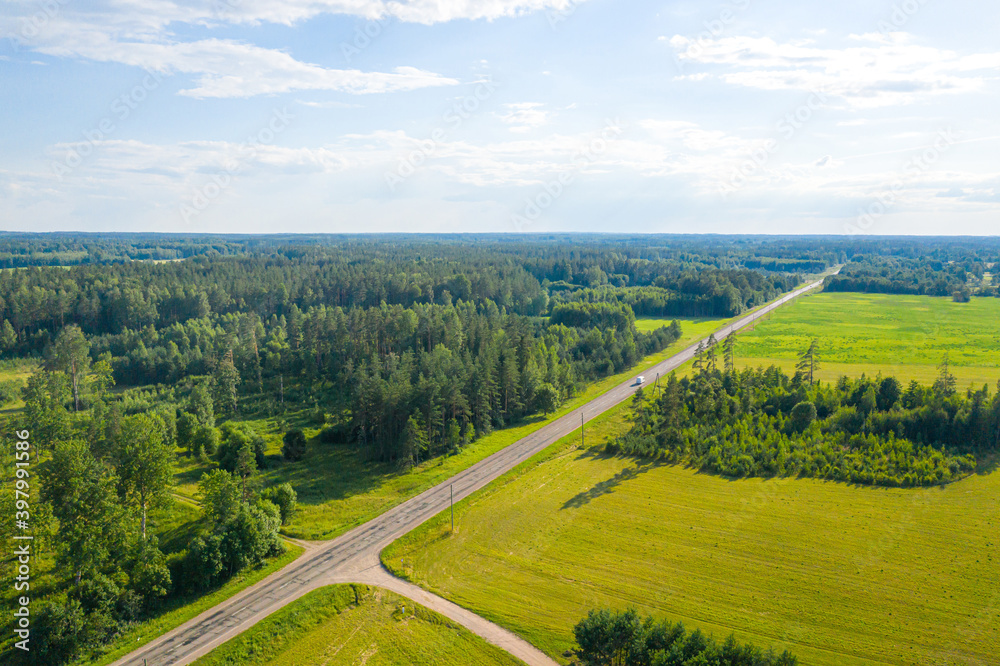 aerial view on rural countryside road through forest, agricultural ...