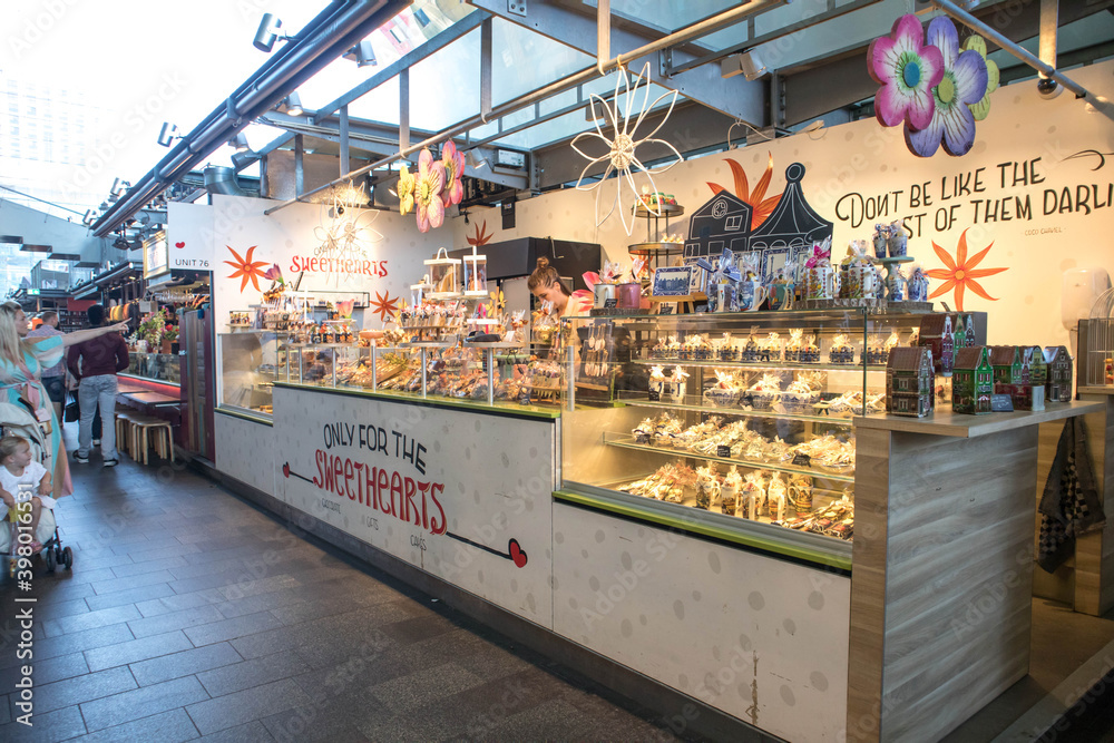 Inside market hall showing food court area with candy sweet ...