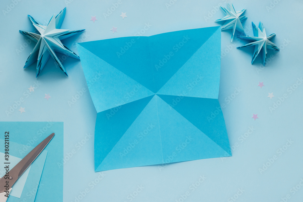 Simple origami 3D Christmas tree made from blue paper. Step by step ...