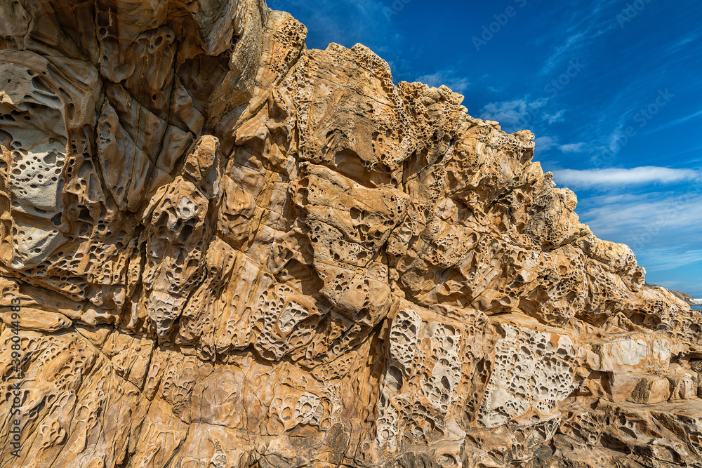 Sandstone cliff with honeycomb weathering n blue sky background Stock ...