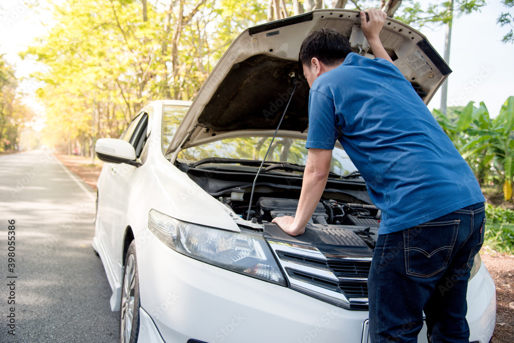 An Asian man opens the bonnet to check the engine compartment. Because ...