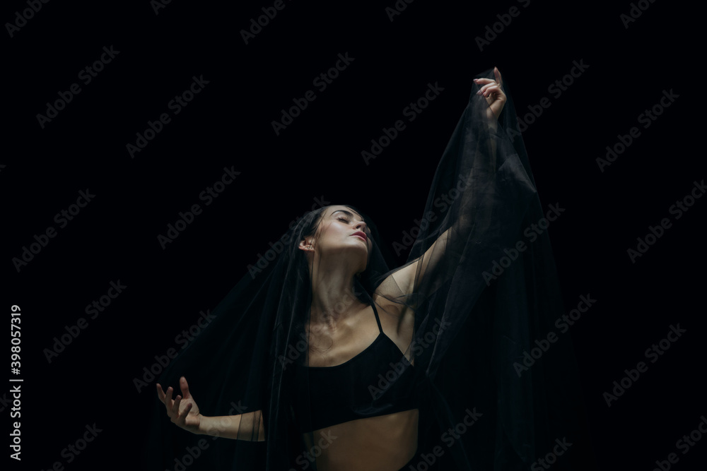 Night. Graceful classic female ballet dancer isolated on black studio ...