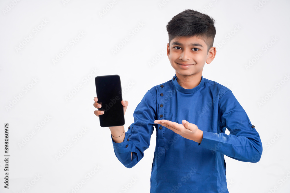 Cute indian little boy showing smart phone screen with copy space over ...