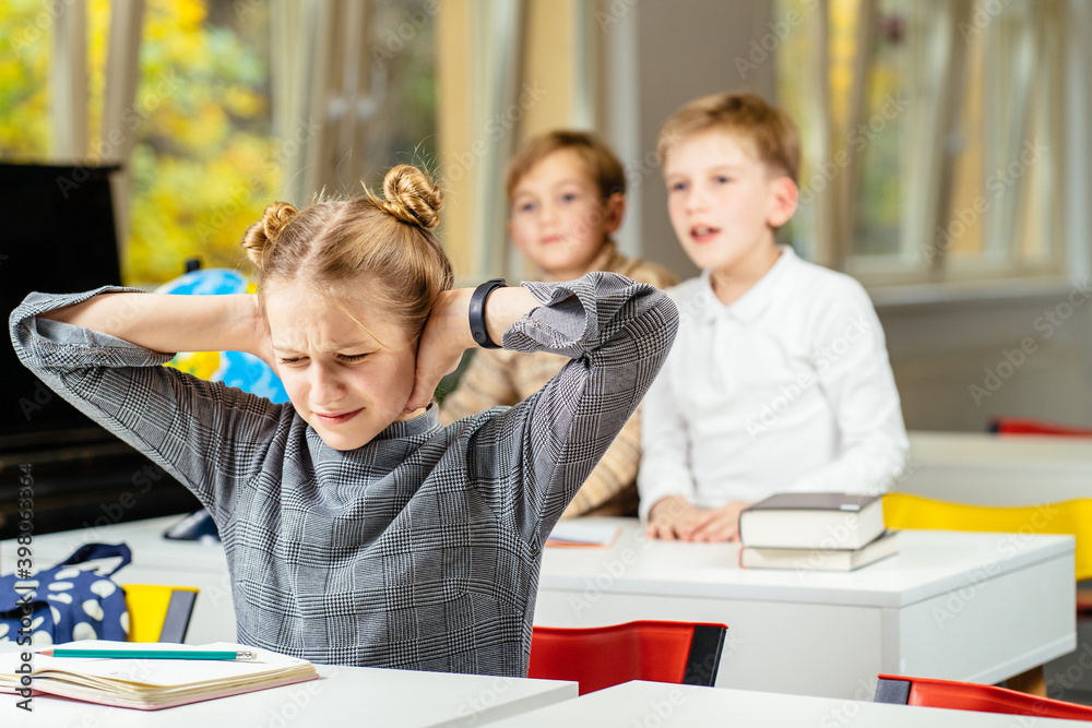 Stressed school girl child, pupil, bullying victim being by classmates ...