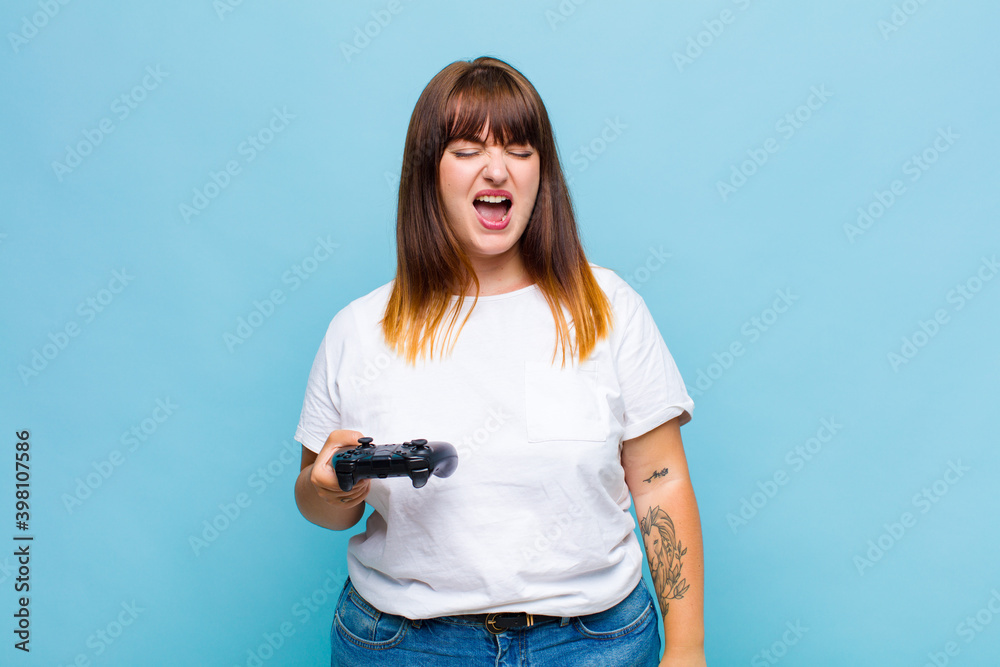 plus size woman shouting aggressively, looking very angry, frustrated ...