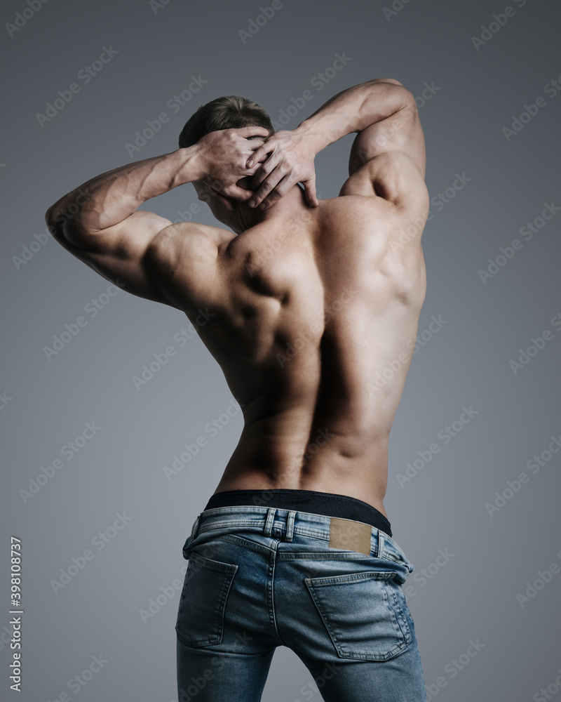 Muscle back of fitness male model in studio Stock Photo | Adobe Stock
