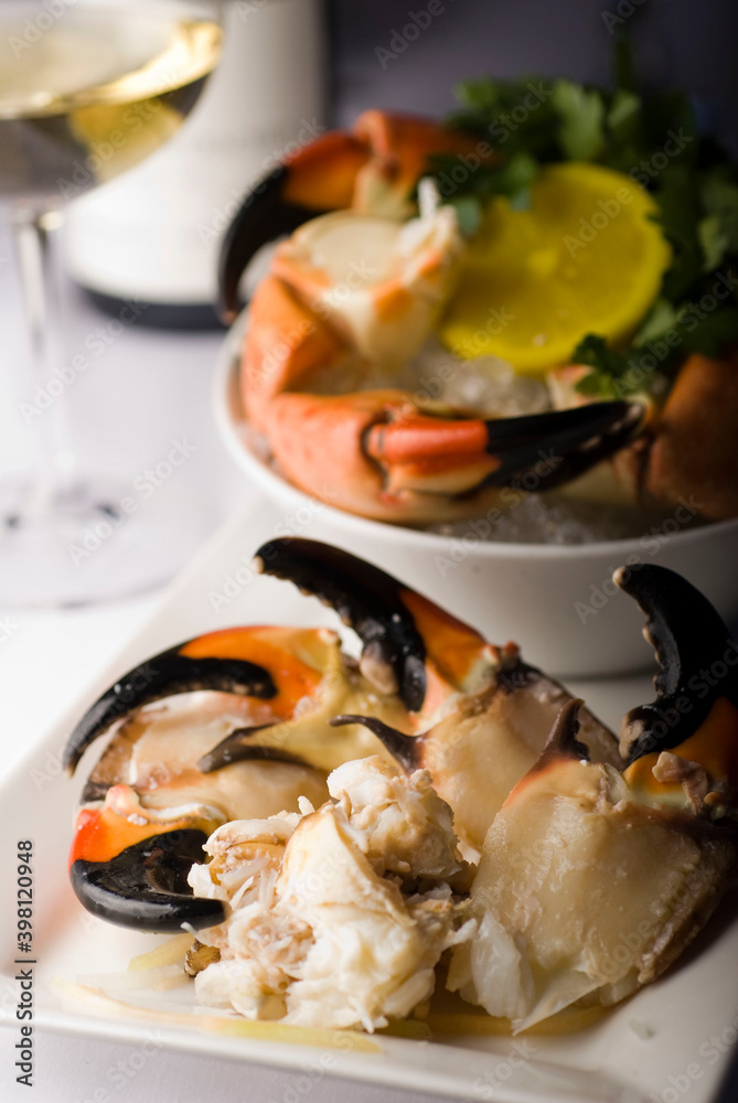 Stone crab claws. Colossal Crab claws served with lemons, spicy ...