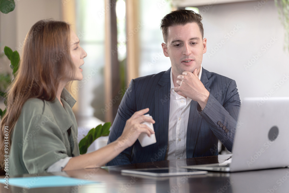 Two professional business people working together in office. Indoor ...