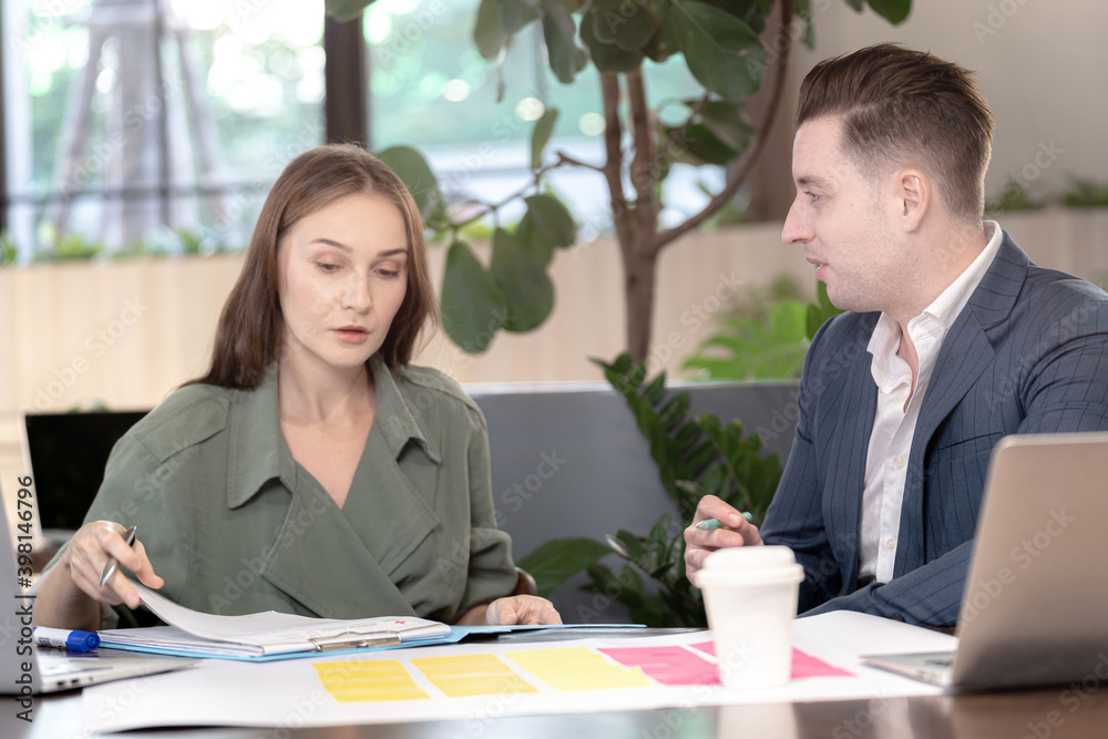 Two professional business people working together in office. Indoor ...