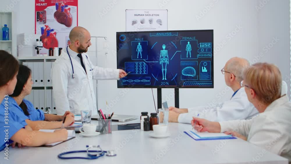 Specialist surgeon presenting human internal structure in front of ...