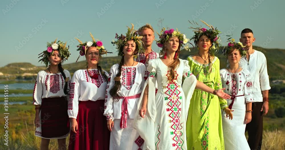 Beautiful young women in Slavic dresses with embroidery and a wreath on ...
