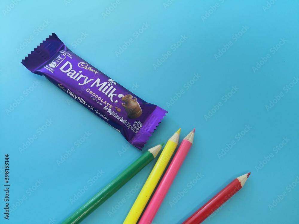Cadbury Dairy Milk chocolate bar over blue background Stock Photo ...