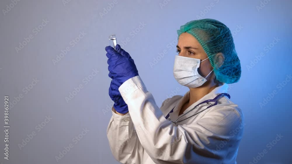 Female Doctor Drawing Up a Syringe with COVID-19 Vaccine from Vial. New ...