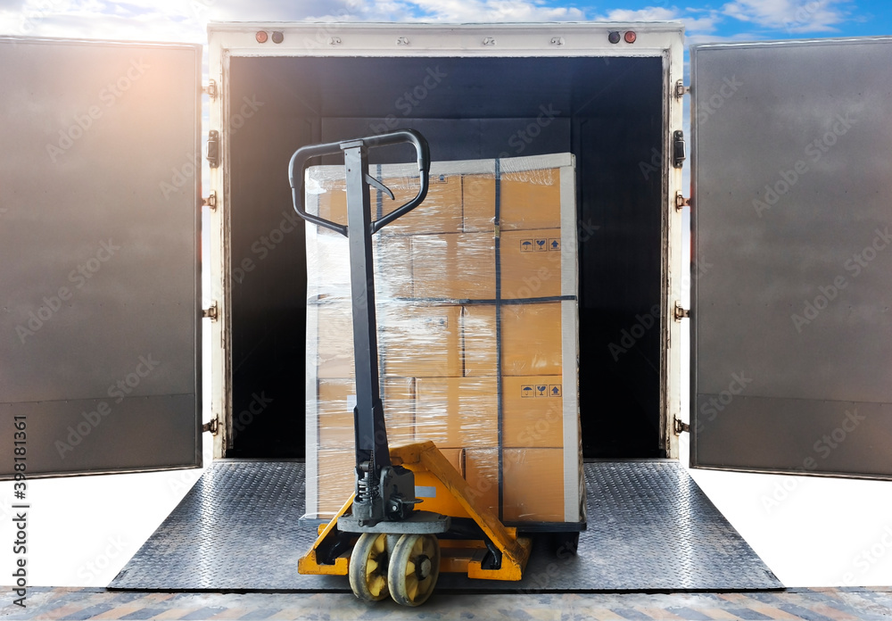 Stacked cardboard boxes on pallet rack loading into shipping container ...