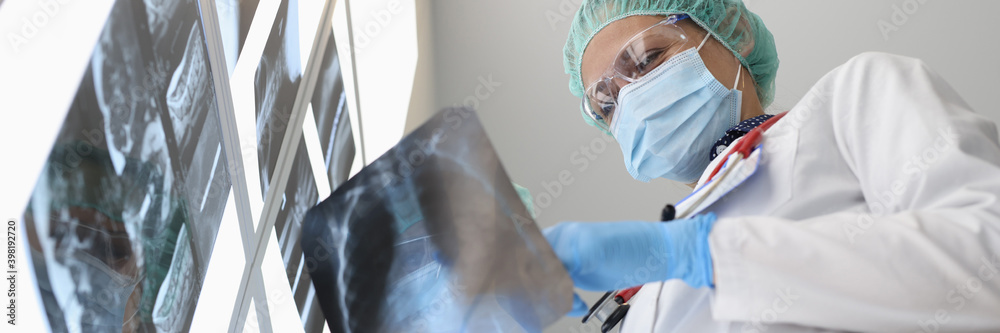Doctors examine an X-ray when discussing it. Examination of internal ...
