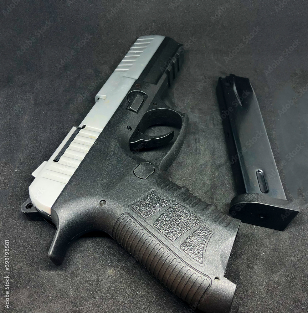 Hand gun top view on black background. 9mm pistol with ammo on the dark ...