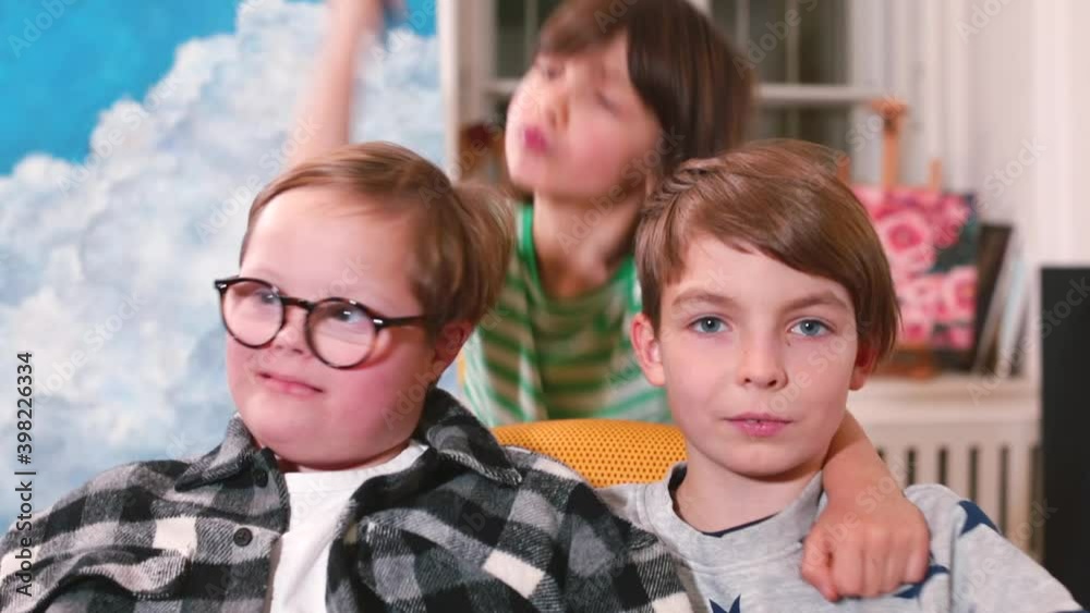 Portrait of cheerful classmates, boy shows V-sign. Boys educated in an ...