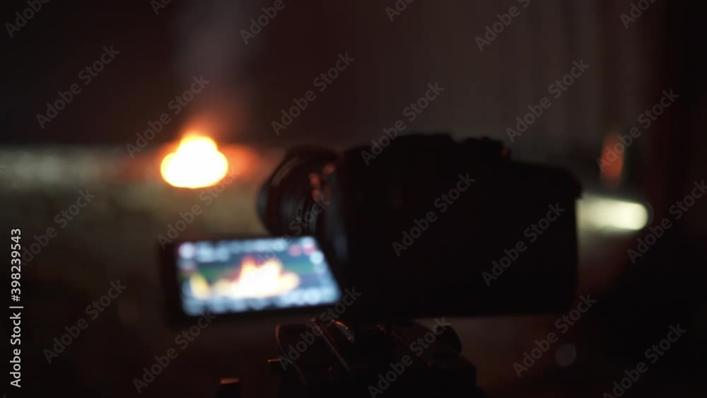 Process of shooting a big fire on professional camera with tripod in ...
