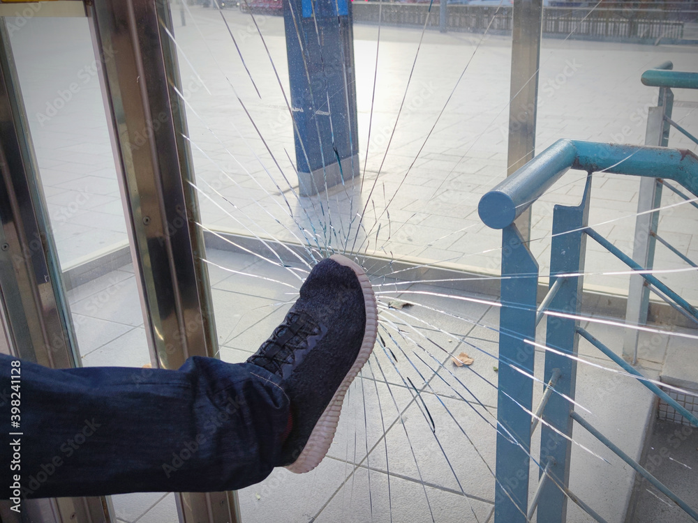 A violent male, boy, man, vandal,angry person breaks and destroys a ...