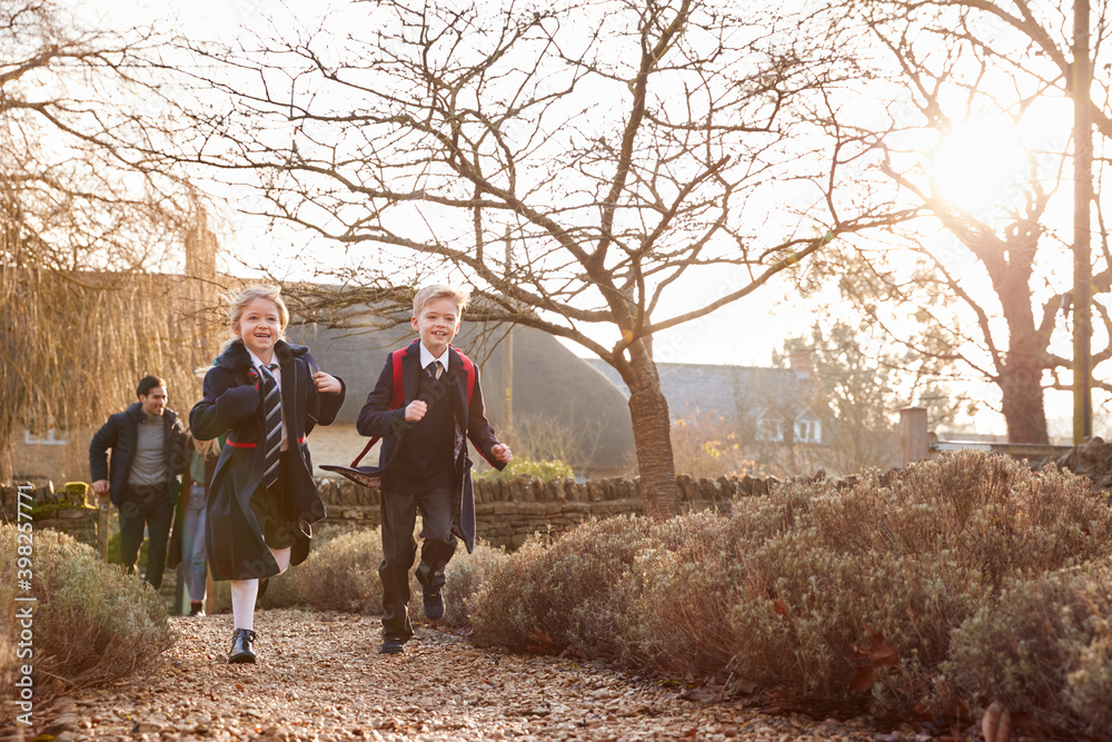 Parents Returning Home From School With Children Wearing School Uniform ...