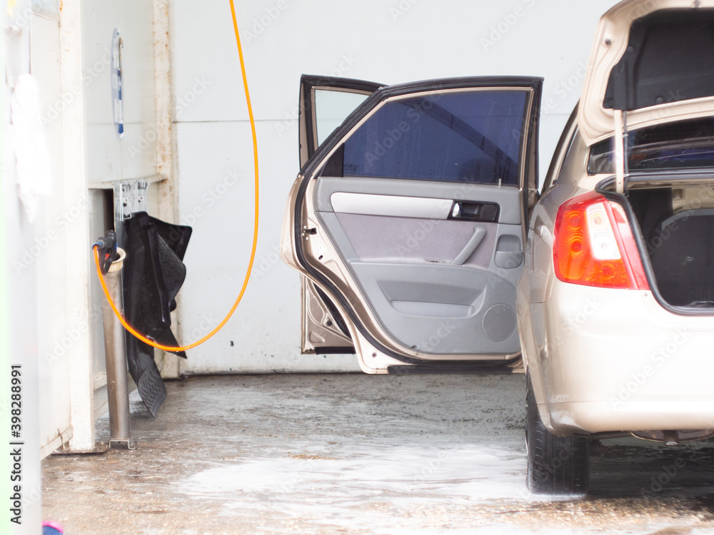 car wash. washed car in the box. wiping open car doors at the car wash ...