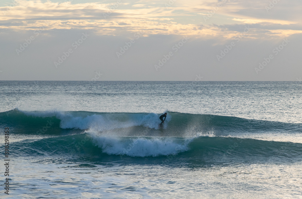 Young surfer catching perfect surf wave at the beach of El Palmar ...