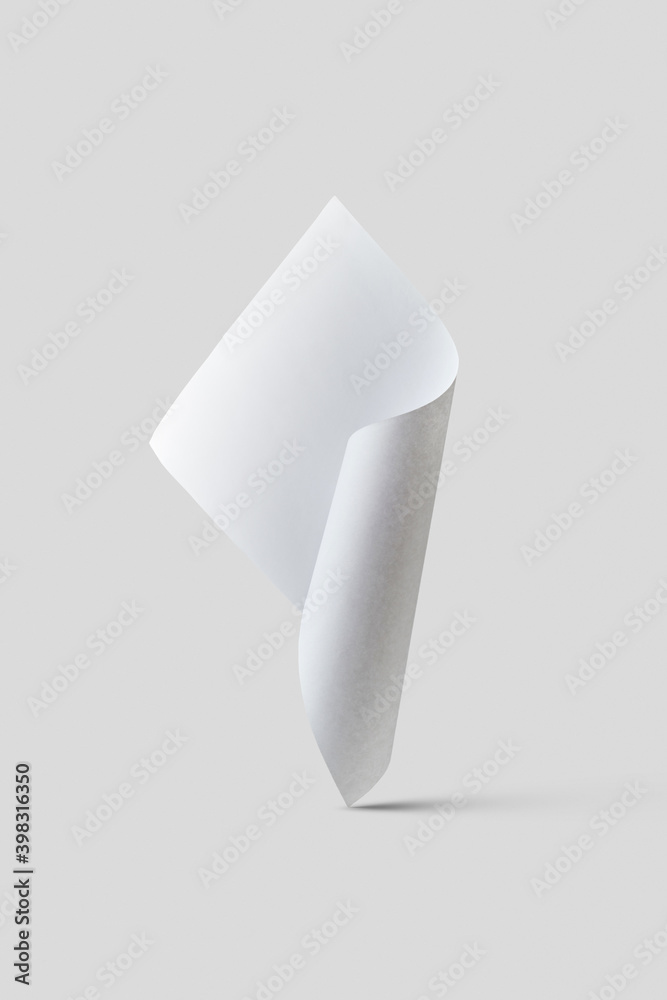 Blank rolled paper vertically floating. Stock Photo | Adobe Stock