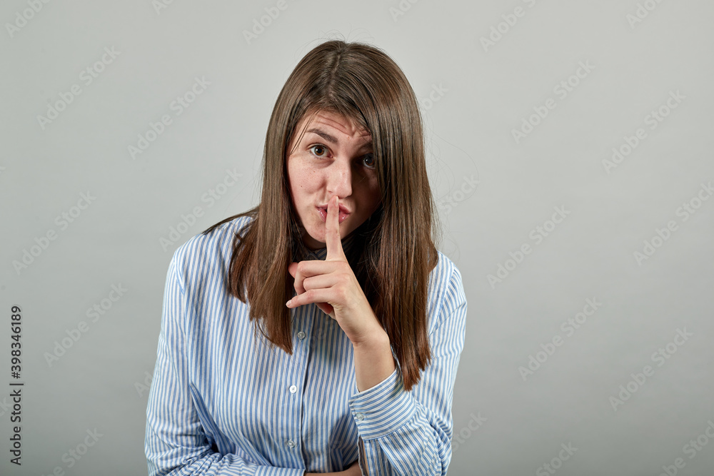 Index finger on lips, silence gesture, shhh quiet, asks for ...